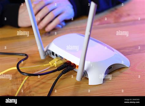 Router With Connected Ethernet Cables On Table And Person S Hands Stock Photo Alamy