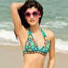 A Model Poses In A Designer Green Bikini During The Photoshoot