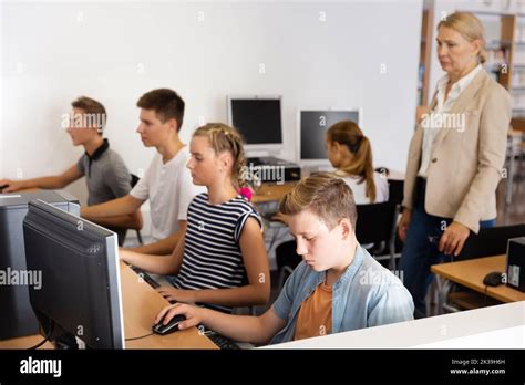 Babes Working With Computers In Classroom Stock Photo Alamy