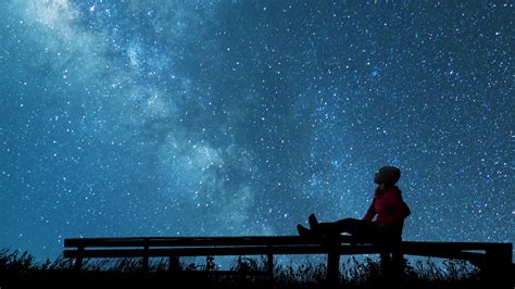 Woman Looking Up At Night Sky