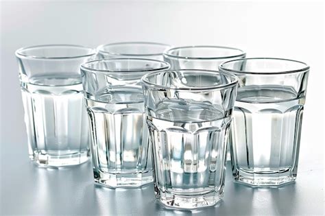 Premium Photo Water Glasses Filled To Different Levels In A