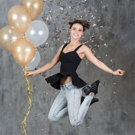 Free Photo Woman Jumping With Orange Balloons