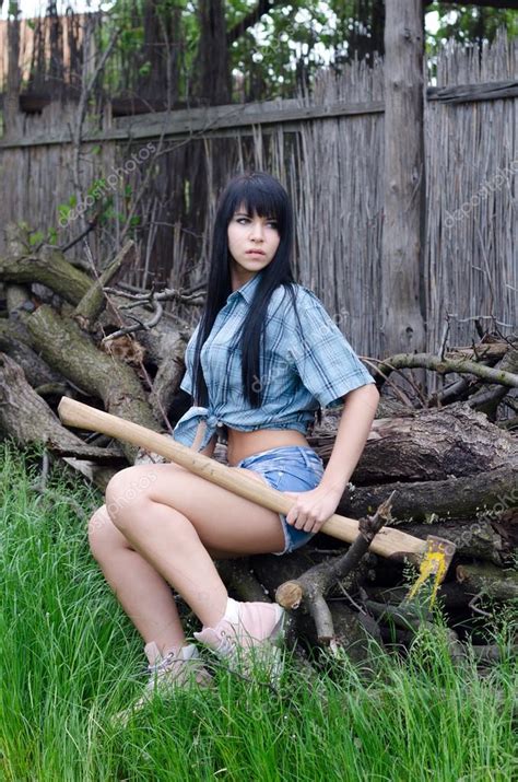 Beautiful Sexy Female Woodcutter Resting After Cutting Wood In S Stock Photo By SolidPhotos