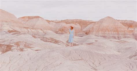 푸른 드레스를 입은 여자가 사막에 서 있다 사진 Unsplash의 사막 풍경 이미지