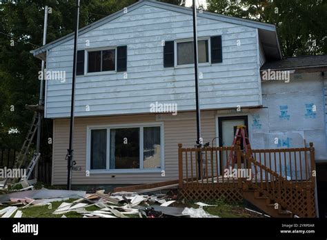 Old Aluminum Siding With Peeling Paint On The Top Portion Of A Split