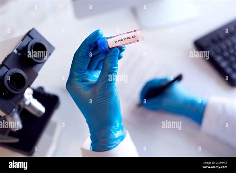 Close Up Of Lab Worker Conducting Research Using Microscope Holding
