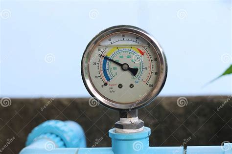 Circular Water Pressure Meter Attached To Blue Pvc Water Pipe To Measure Tap Water Pressure