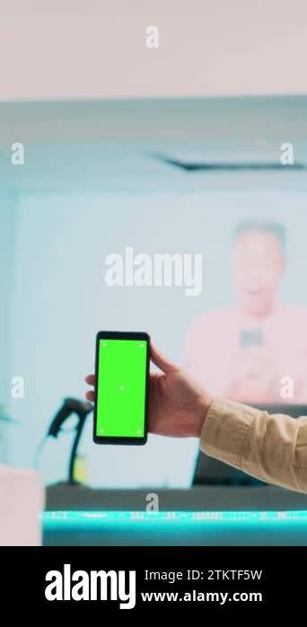 Vertical Video Man Worker Holding Smartphone With Greenscreen Showing Blank Copyspace Template