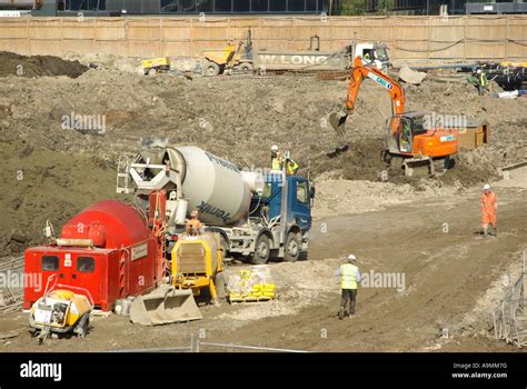 Construction Site Ready Mix Concrete Truck Unloading Into Drum For Pumping To Foundations Stock