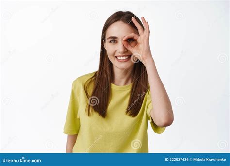 Zero Problems Smiling Brunette Girl Shows Okay Ok Sign Over Eye Pleased And Praise Thing