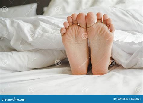 Young Woman`s Foot Laying On White Bed In Bedroom Stock Image Image