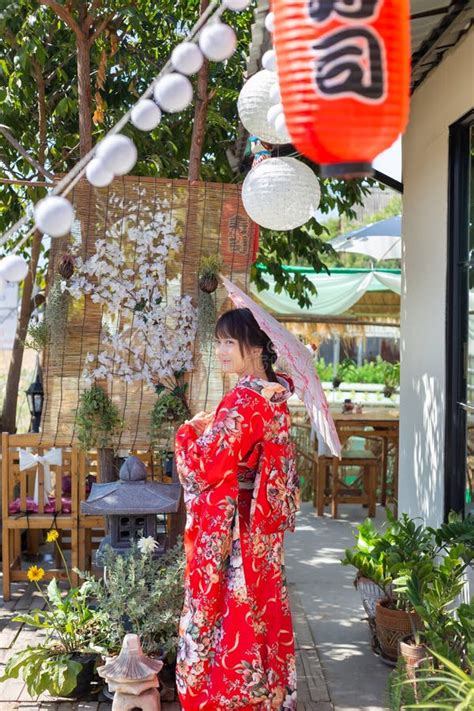 The Girl Is Wearing A Red Traditional Kimono Which Is The National