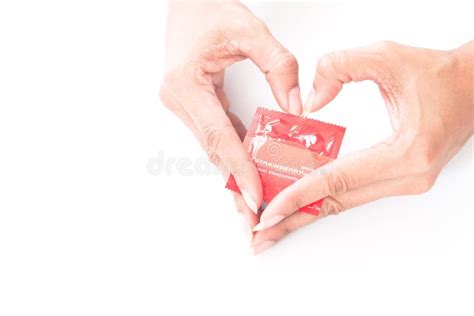 Woman`s Hands With Condom And Heart Shape Hand Sign Love And Sa Stock