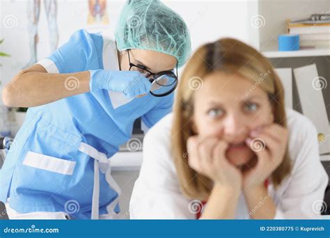 Proctologist With A Magnifying Glass In His Hand Showing Rectum