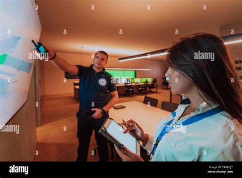 Group Of Security Operators Working In A Data System Control Room Technical Operators Working At