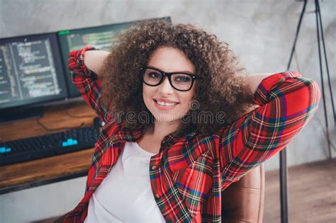 Smiling Young Professional Programmer Relaxing In Modern Workspace With
