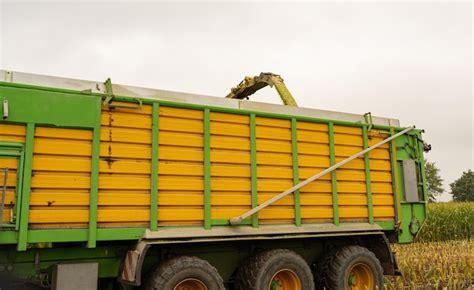 Premium Photo Agricultural Machinery Tractor And Chopper During The Corn Harvest