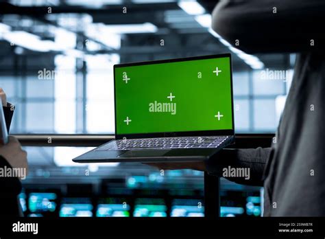 Engineers In Data Center Using Green Screen Laptop Implementing Predictive Analytics Scripts