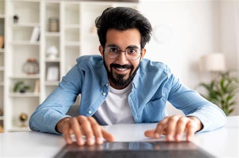 Premium Photo Pov Shot Of Excited Young Indian Man Using Laptop At Home