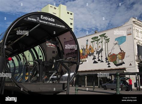 Tubular Railway Articulated Urban Buses And Poty Lazzarotto Panel On The Side Of Building Stock