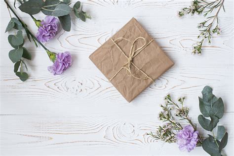 위 로부터 흰색 테이블에 크 라프 트 지와 꽃에 싸여 선물 또는 현재 상자 평평한 평 신도 스타일링 텍스트의 공간을 복사 합니다 어머니 또는 여자 하루에 아늑한 아침 식사