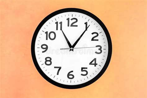 Modern Analog Clock Round In Black And White On An Orange Background