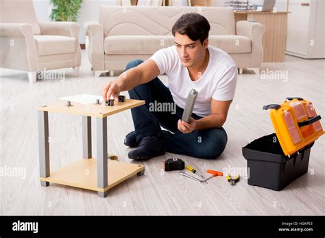 Man Assembling Shelf At Home Stock Photo Alamy