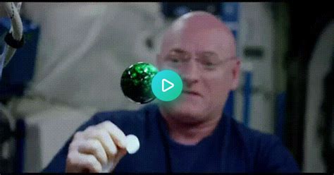 Adding An Effervescent Tablet To A Floating Ball Of Colored Liquid In