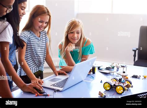 Three Female Babes With Teacher Building Robot Vehicle In After Babe Computer Coding Class