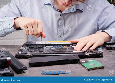 Man Disassembles A Laptop Computer Service And Repair Concept Laptop