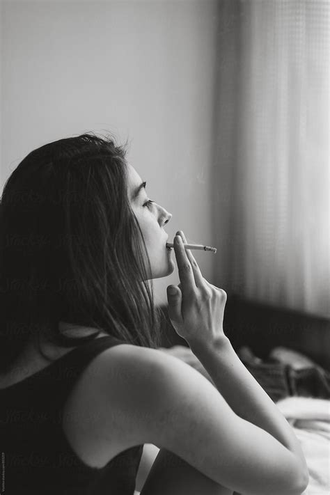 Beautiful Woman Smoking A Cigarette Indoor By Stocksy Contributor