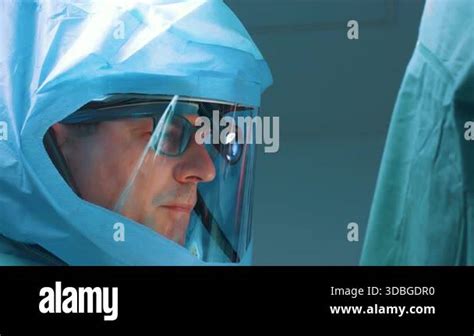 Close Up Side Profile Of A Male Surgeon In A Sterile Helmet And Head