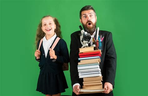 Premium Photo Funny Father Or Teacher With School Girl Daughter Hold Big Stack School Textbook