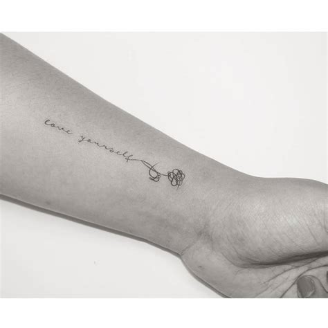 Love Yourself And Flower Tattooed On The Wrist
