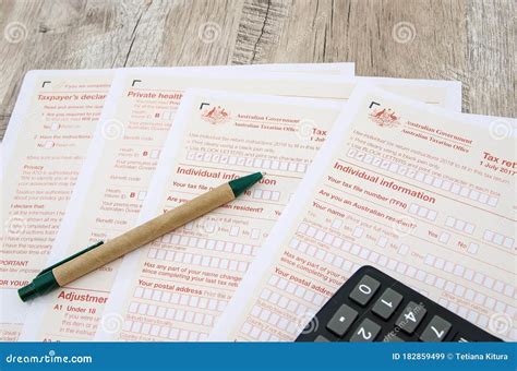 Australian Tax Forms With Pen And Calculator On A Wooden Table Editorial Stock Image Image Of
