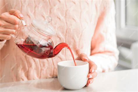 Free Photo Woman Pouring Tea In Cup