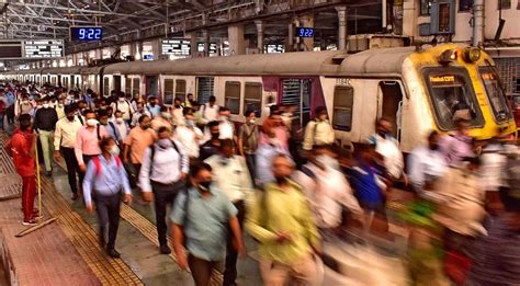 Passengers Deboard From A Local Train At A Railway Station