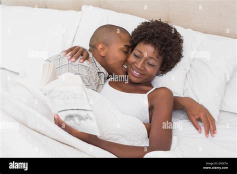 Happy Couple Lying In Bed Cuddling Stock Photo Alamy