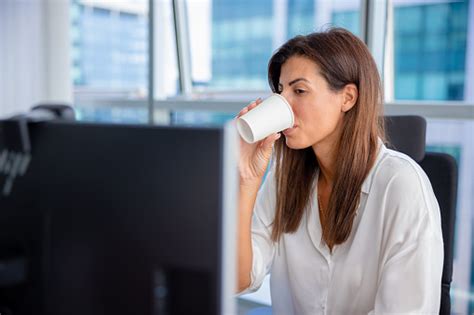 책상에서 종이 컵에서 커피를 마시고 모니터를 보고있는 사업가 30 34세에 대한 스톡 사진 및 기타 이미지 30 34세 갈색 머리 경영자 Istock