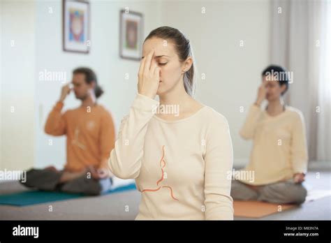 A Group Of Young People Practising Yogic Breathing Technique Called