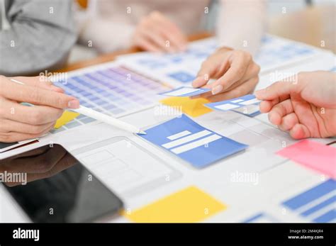 Team Of Mobile Application Designer And Developer Are In The Meeting Discussing And