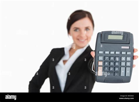 Woman In Black Suit Showing A Calculator Against White Background Stock Photo Alamy