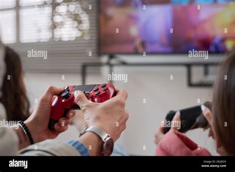 close up of mom and daughter pushing buttons on joysticks while playing