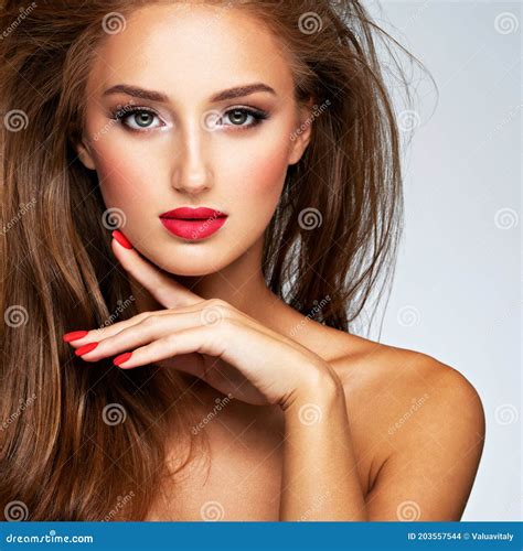 Face Of Young Woman With Red Nails Lipstick And Long Brown Hair Model