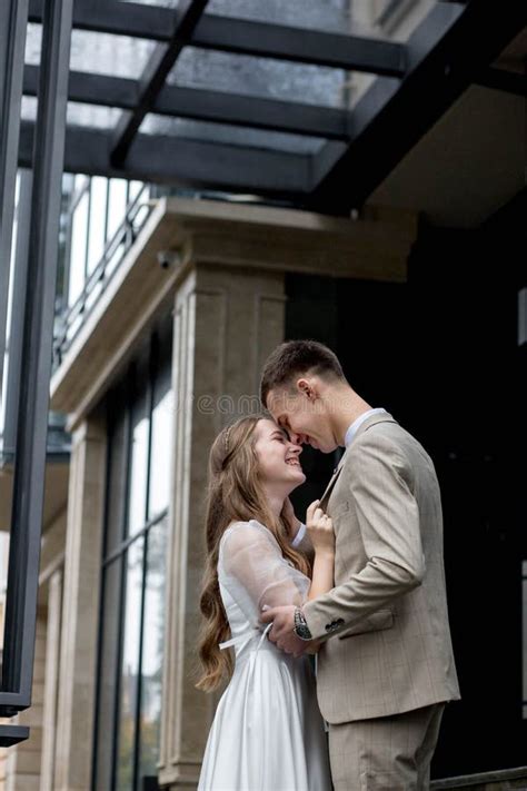 The Bride Looks At The Groom With Loving Eyes Smiling Newlyweds Look Into Each Other X S