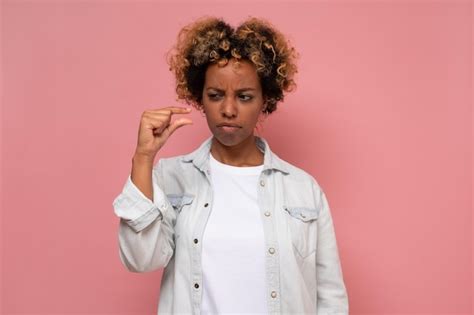 Premium Photo African Young Woman Showing Something Small Finger