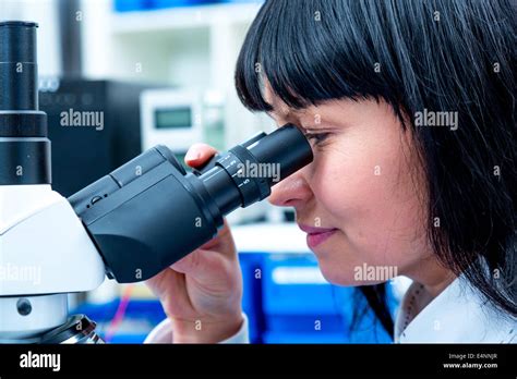 Female Doctor Uses A Microscope Stock Photo Alamy