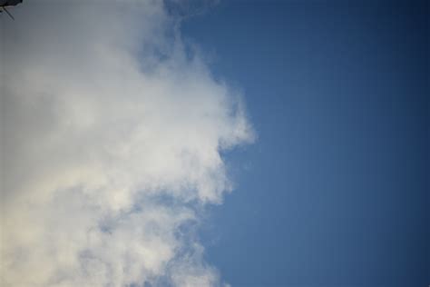 푸른 하늘에 흰 구름 하나 푸른 하늘에 권운 구름을 통해 태양의 광선 태양 광선에 비추는 푸른 하늘에 하얀 비구름 푸른 하늘에 대한 화창한 날씨의 흰색 푸른 구름 0명에