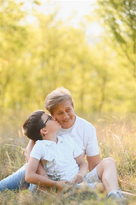 A Beautiful Grandmother Spends Time With Her Grandson In Nature At Sunset Stock Photo Image Of