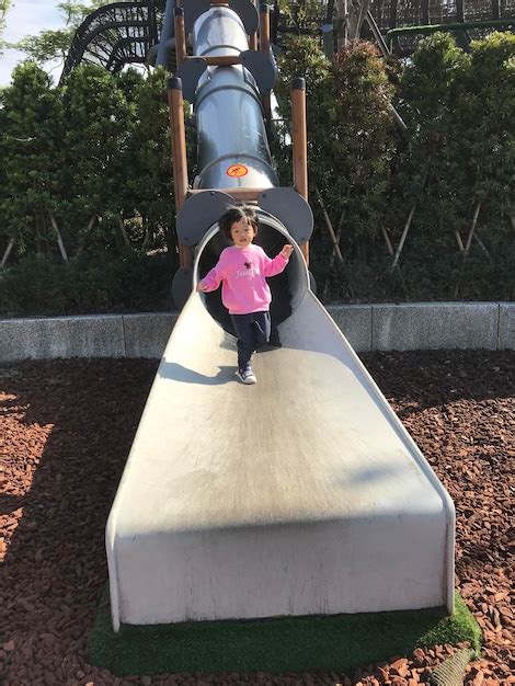 Premium Photo Girl Playing On Slide